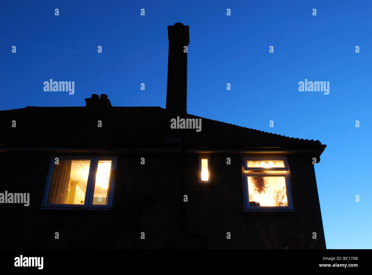 House at twilight with windows Stock Photo - Alamy