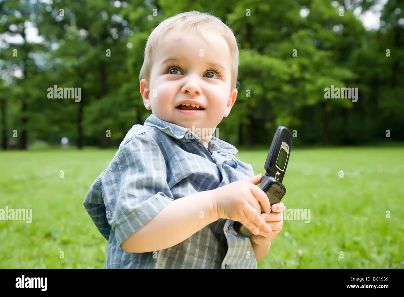 The Surprised Kid With Phone In His Hands Stock Photo - Alamy