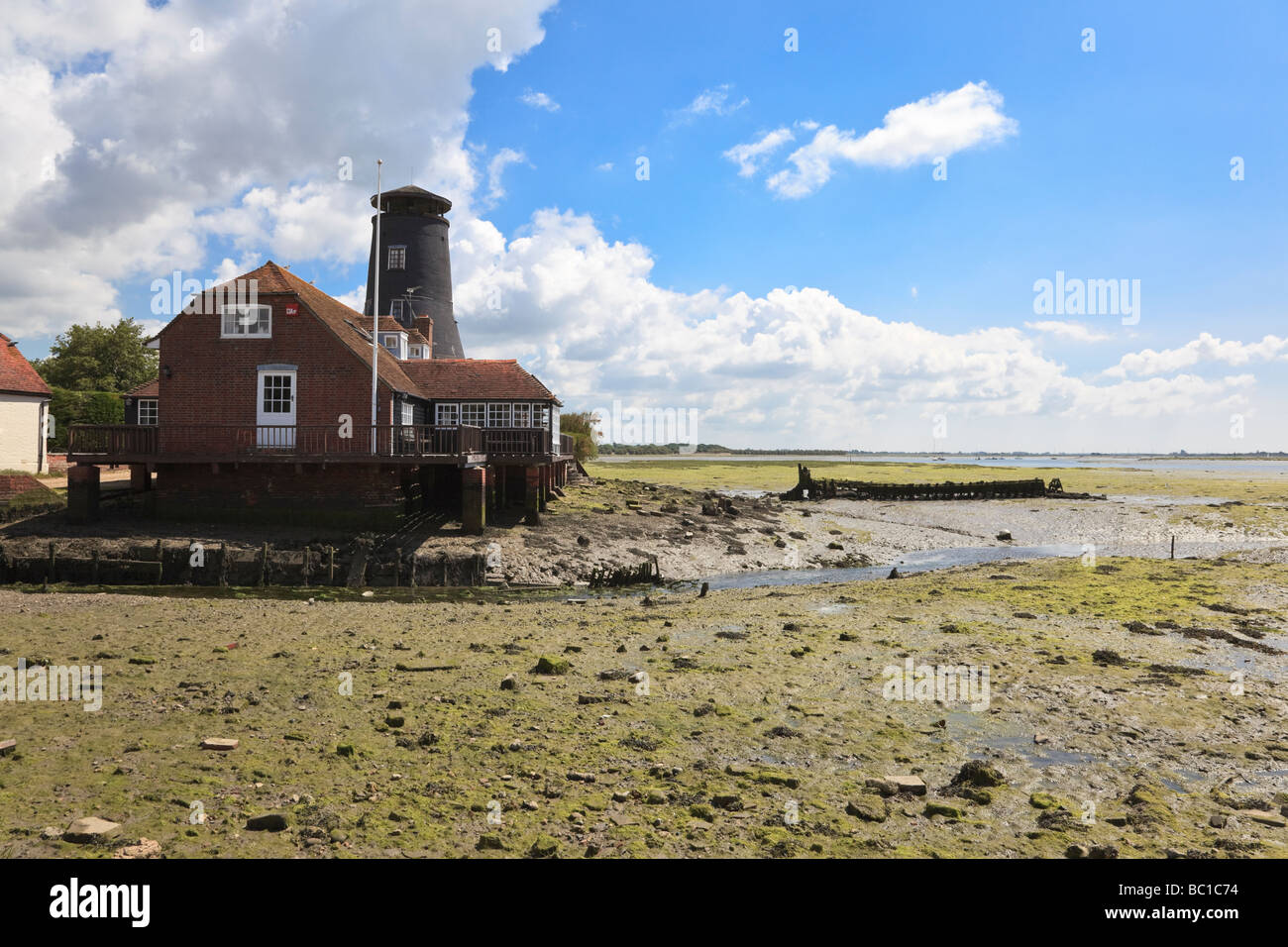 Attractive waterfront mill in the village of Langstone seen at low tide ...