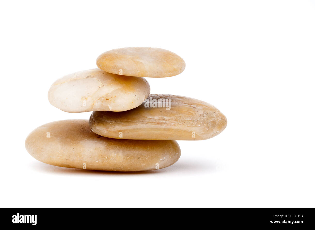 A horizontal image of carefully balanced stacked beige river rocks ...