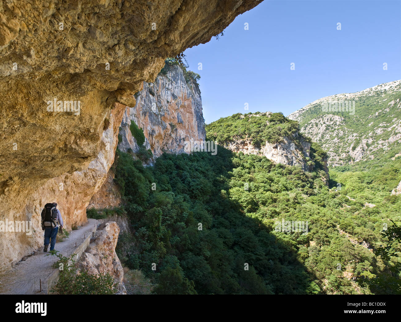 A hiker on a narrow path in the Langadhiotissa gorge between Anavriti ...