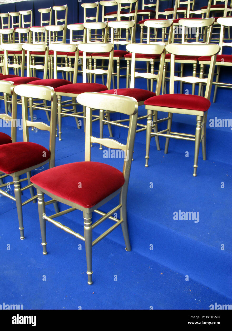 rows of red gold chairs for vip at an outdoor parade event Stock Photo ...