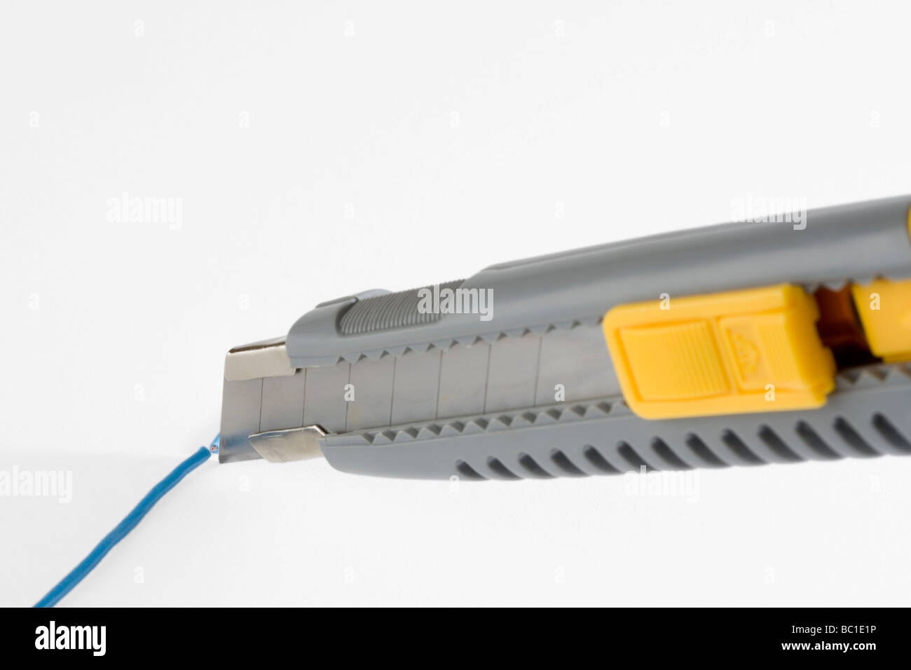 A close up of a craft utility or box knife cutting a wire Stock Photo ...