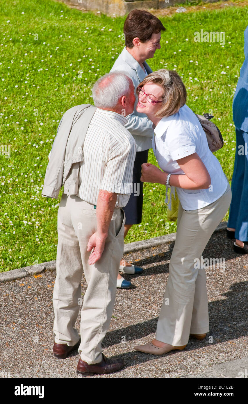 Family / friends greeting / kissing each other outside - France Stock ...