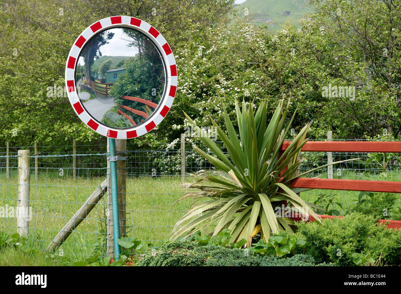 Road safety mirror to enable frives to exit a blind drive Stock Photo ...