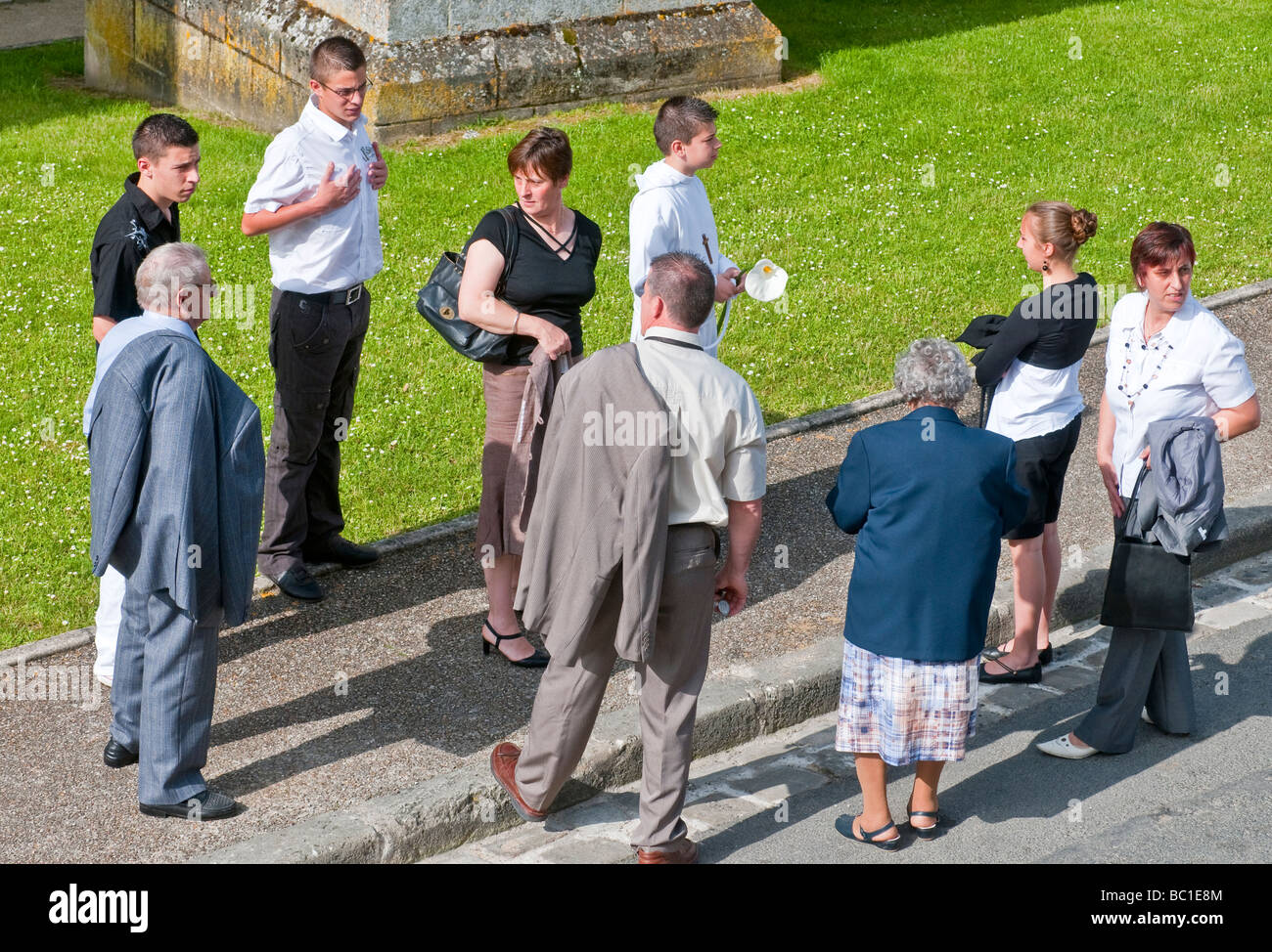 Group of nine people gathering before Sunday Mass in church - France ...