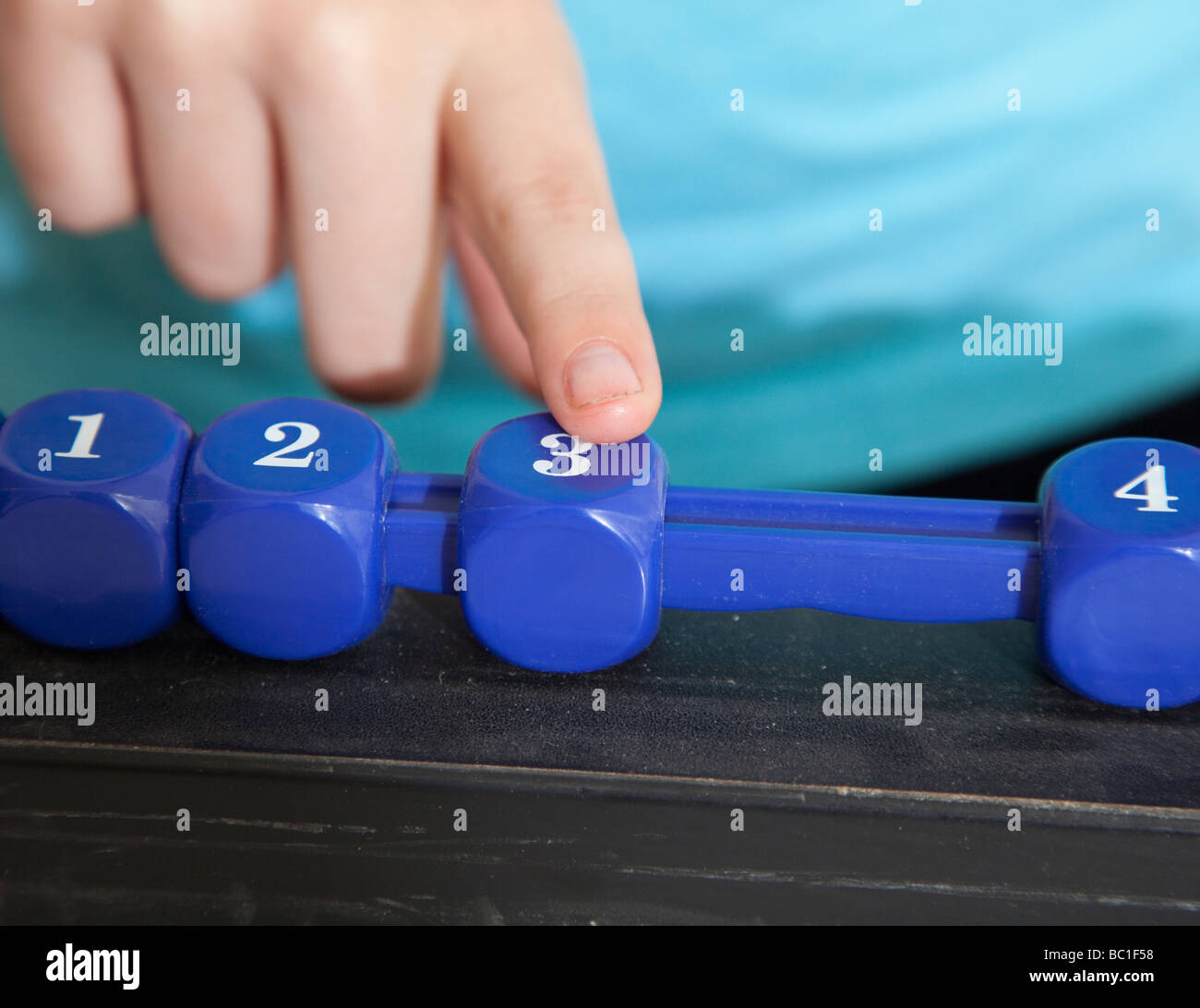 Child moving the number three as she keeps score Stock Photo - Alamy