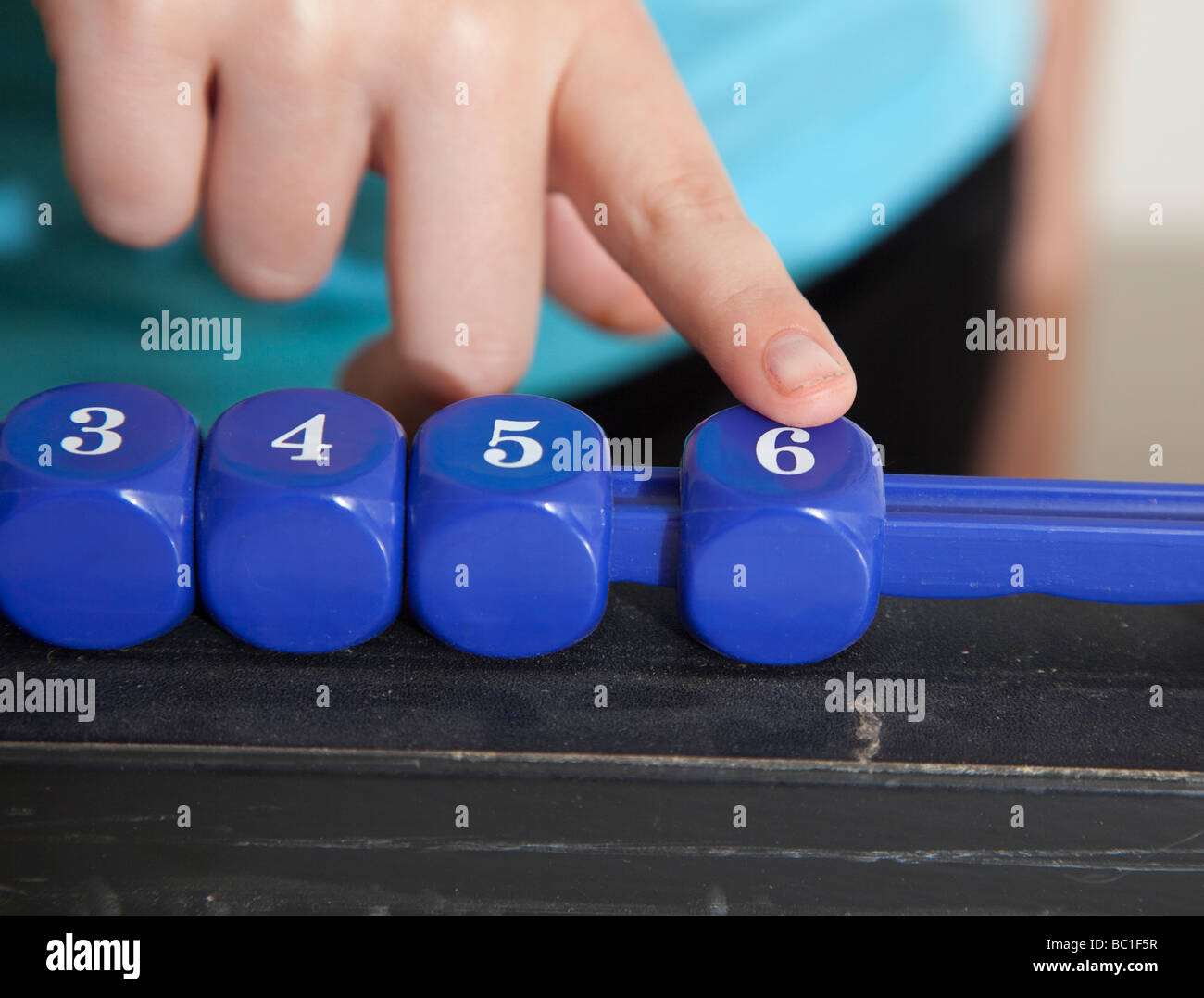 Child moving the number six as she keeps score Stock Photo - Alamy