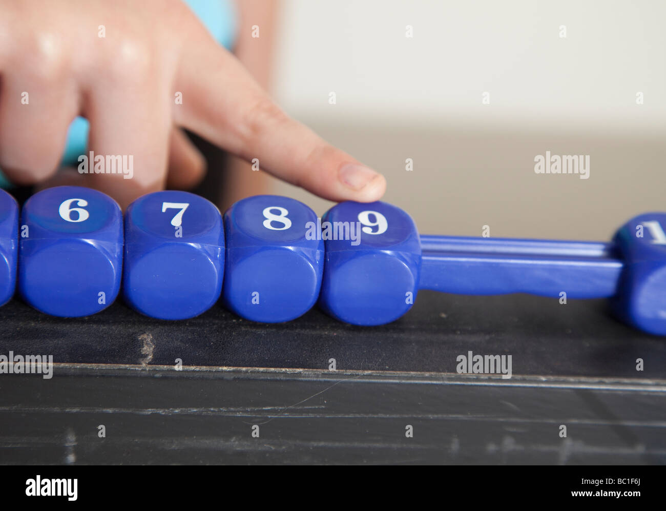 Child pointing to the number nine as she keeps score Stock Photo - Alamy