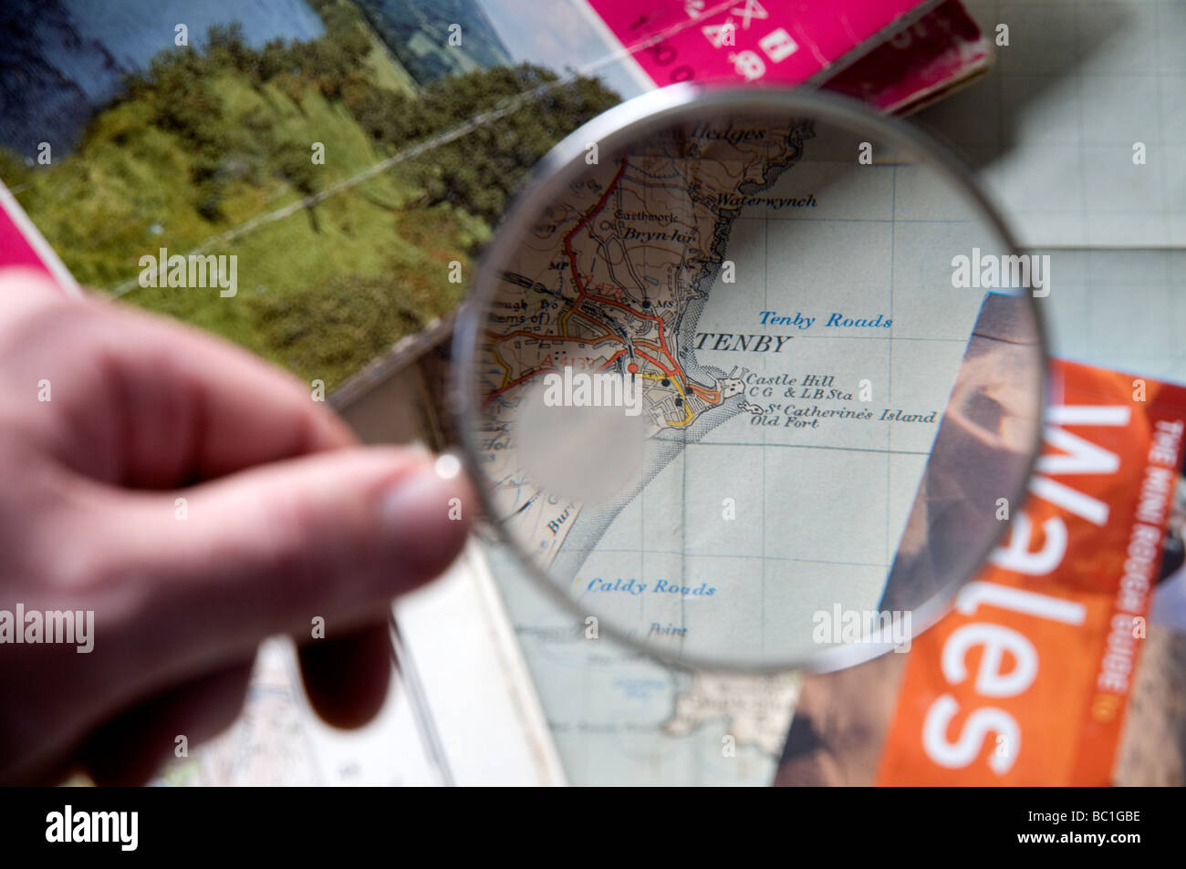 Map of Tenby in west wales shown through a Magnifying glass Stock Photo ...