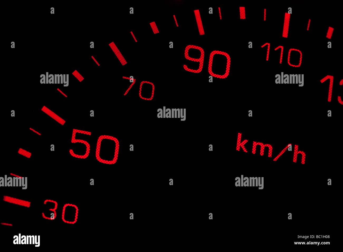 Orange neon speedometer over a black background Shallow depth of field ...