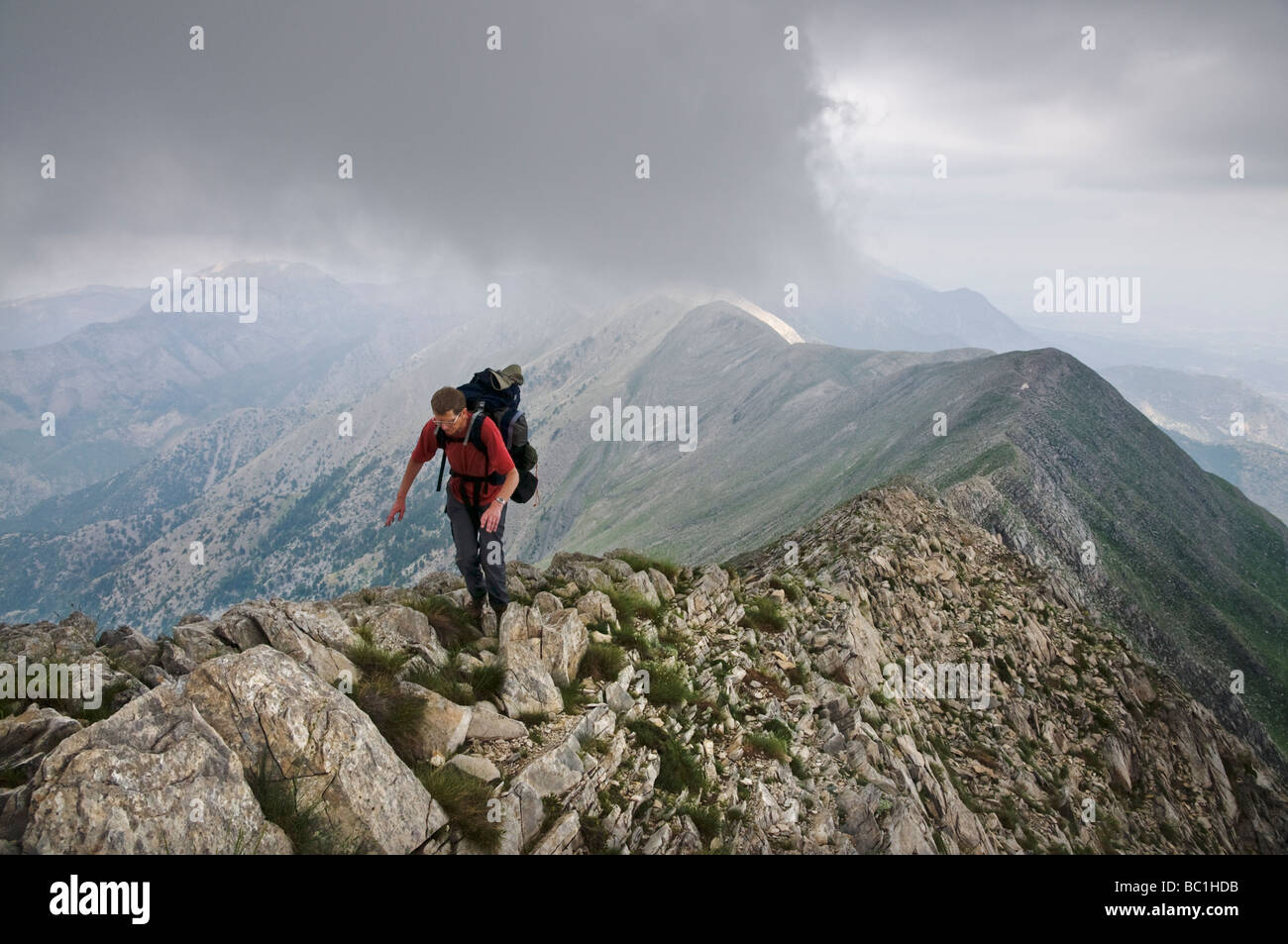 A hiker traversing the Pendadhaktilo ridge, the watershed of the ...