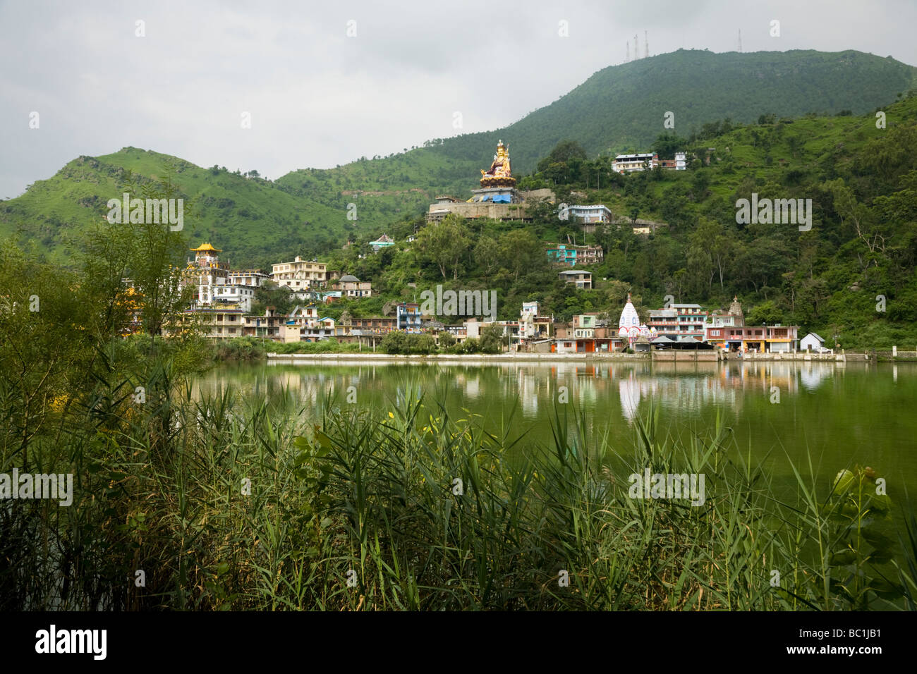 Rewalsar lake, with statue of Acharya Padmasambhav on the hillside ...
