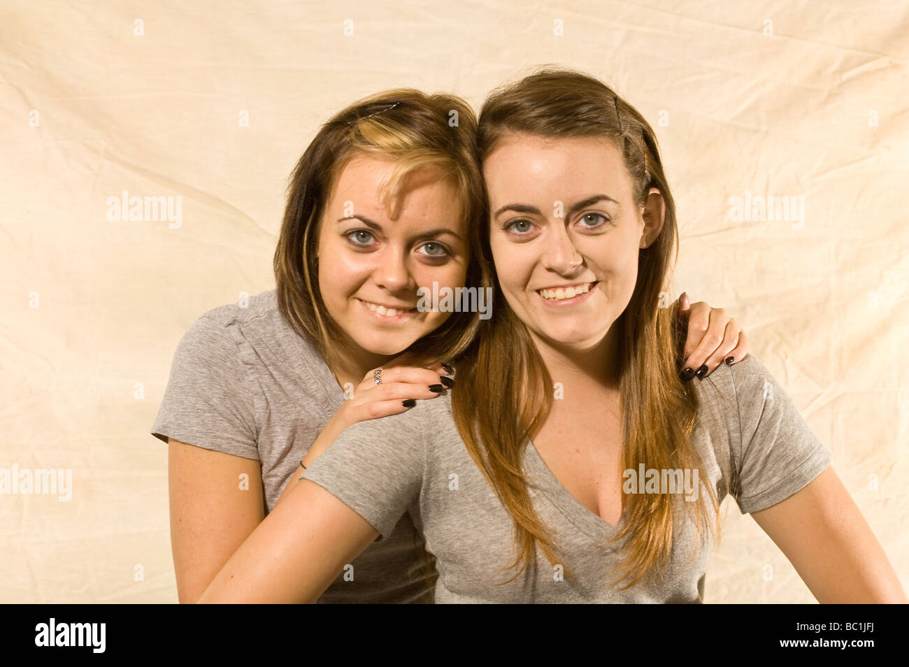 Happy twins in identical clothes Stock Photo - Alamy