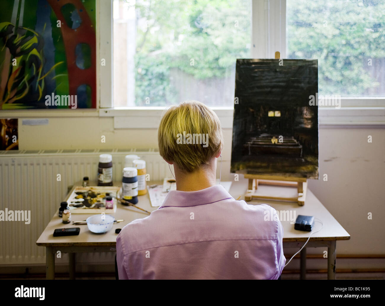 A school student sitting in an art studio painting Stock Photo - Alamy