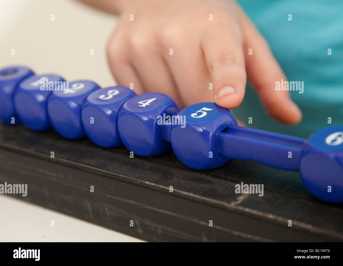 Child moving the number five as she keeps score Stock Photo - Alamy