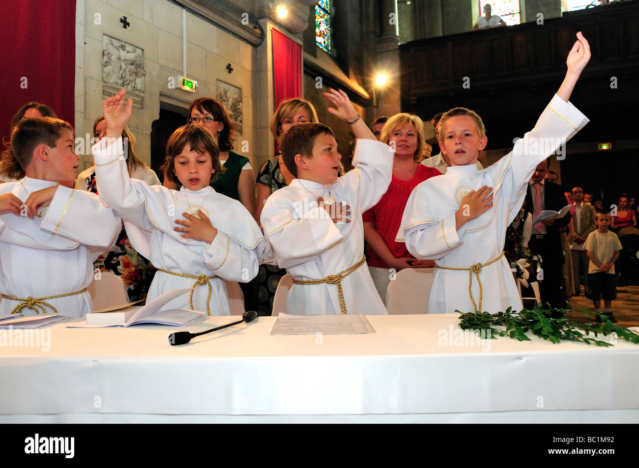 First Communion in Catholic Church children Stock Photo - Alamy