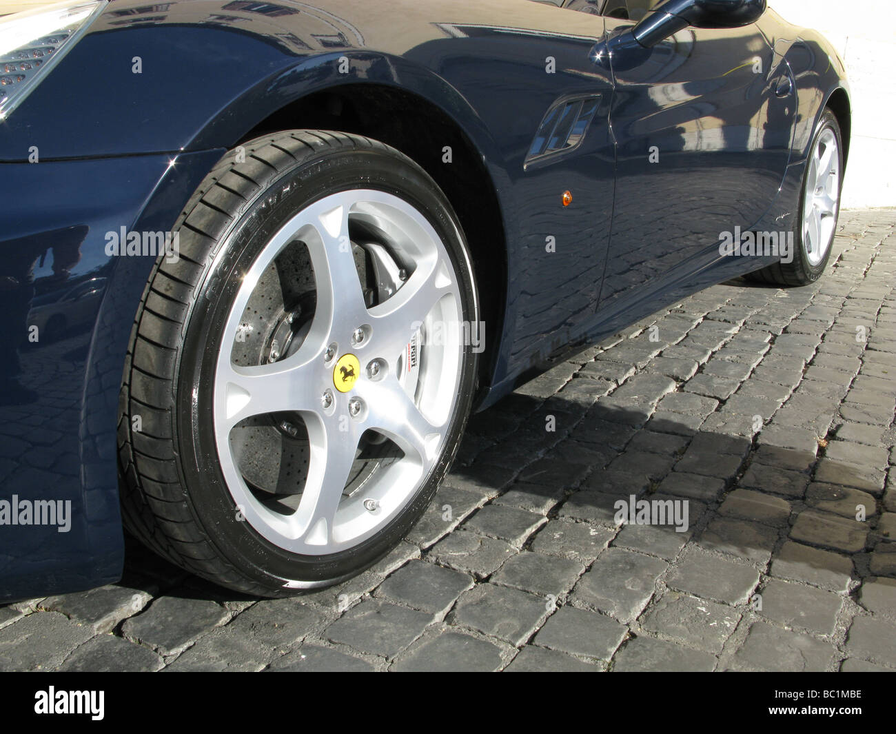 one blue ferrari sports car in street in rome italy Stock Photo - Alamy