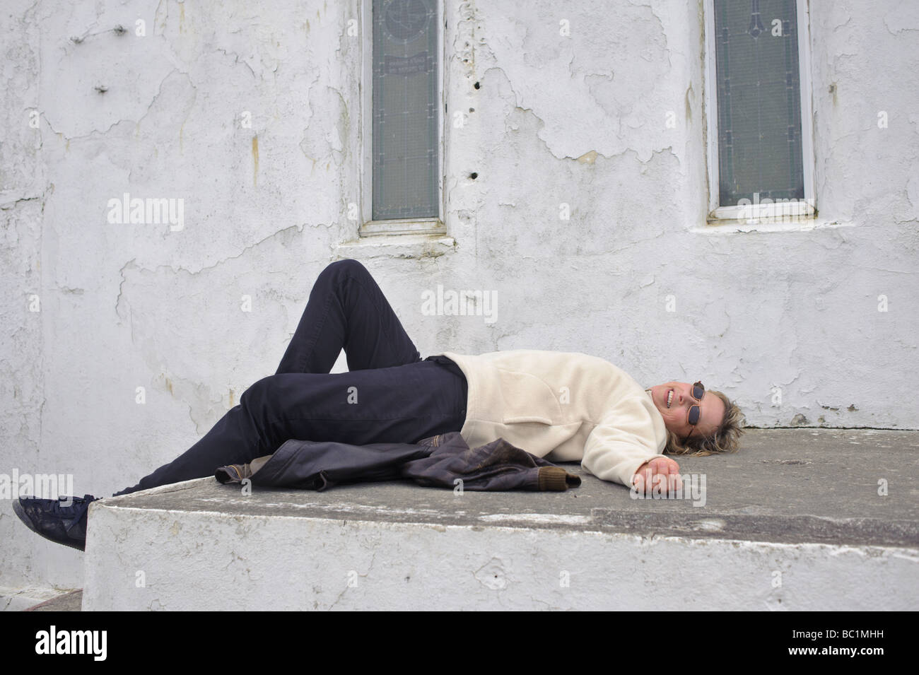 Woman Climber and pilgrim resting exhausted after climbing to the ...