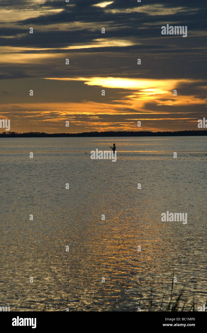 Fishing at sunset Stock Photo - Alamy