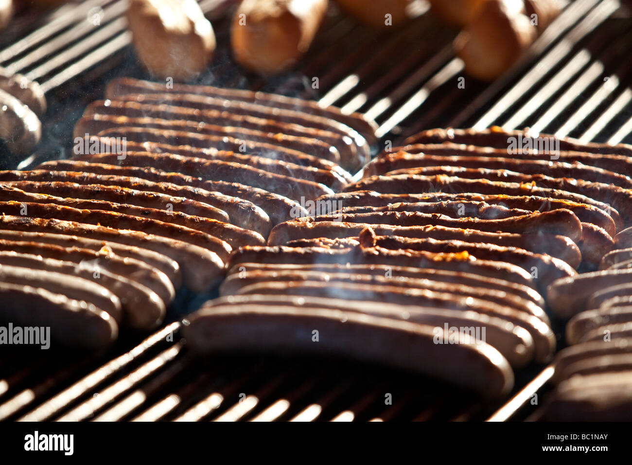Sausages cooking on a barbecue Stock Photo - Alamy