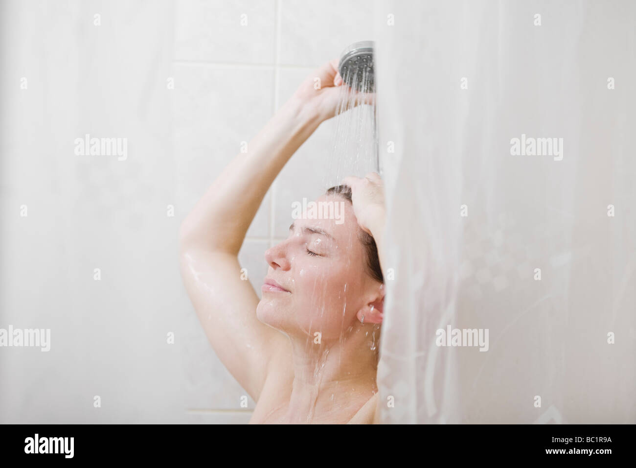 Woman taking shower Stock Photo - Alamy