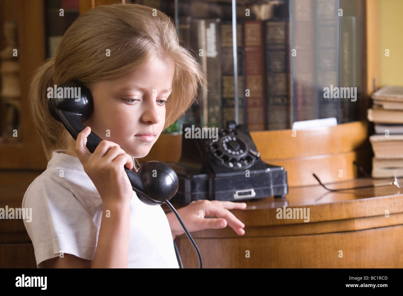 Girl using telephone at home Stock Photo - Alamy