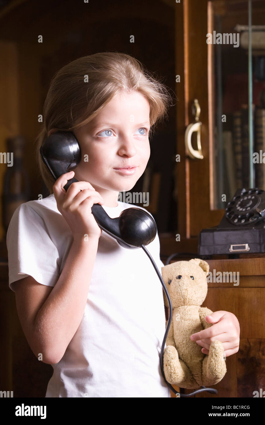 Girl using telephone at home Stock Photo - Alamy
