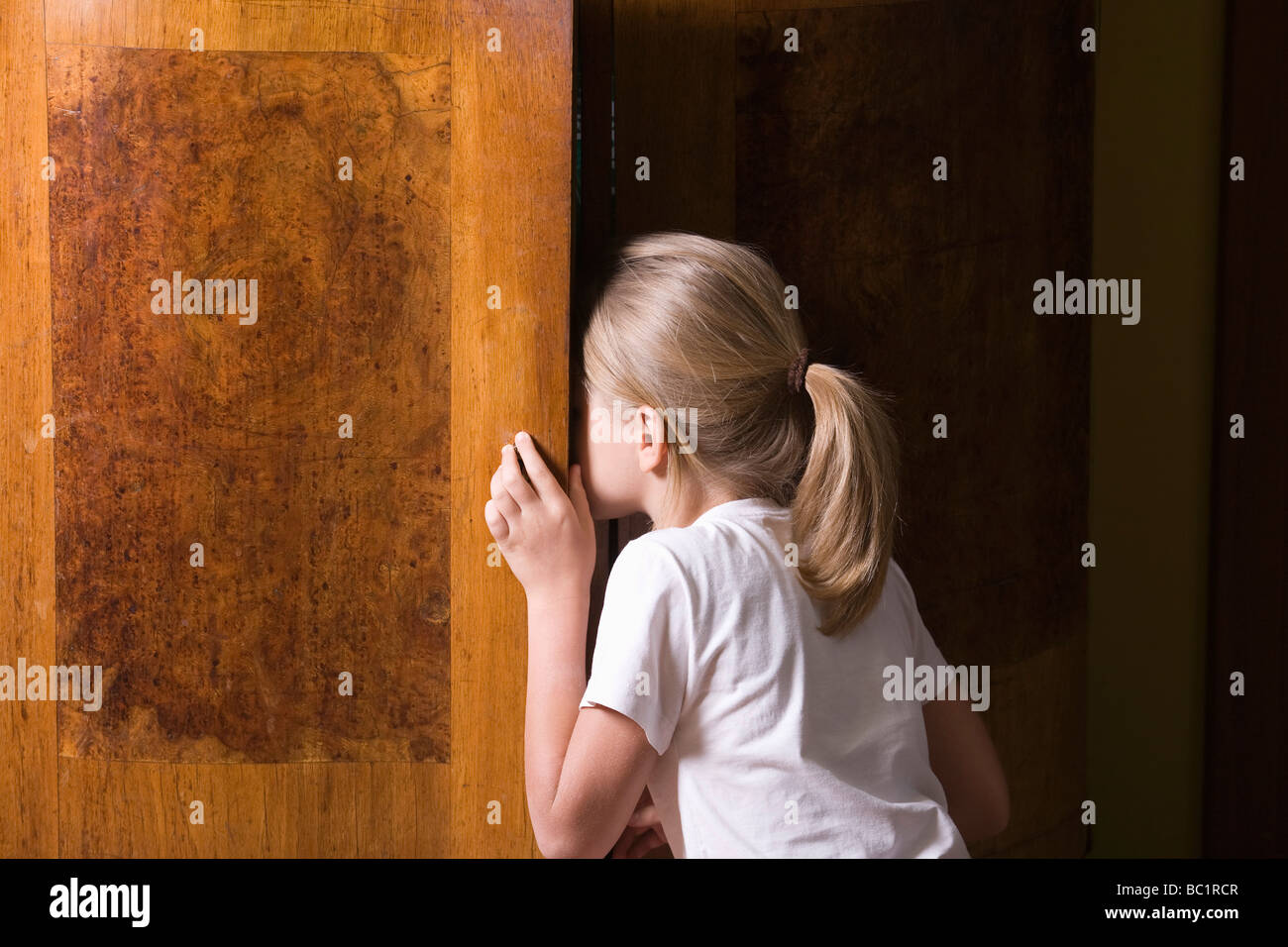 Girl opening wardrobe door Stock Photo - Alamy