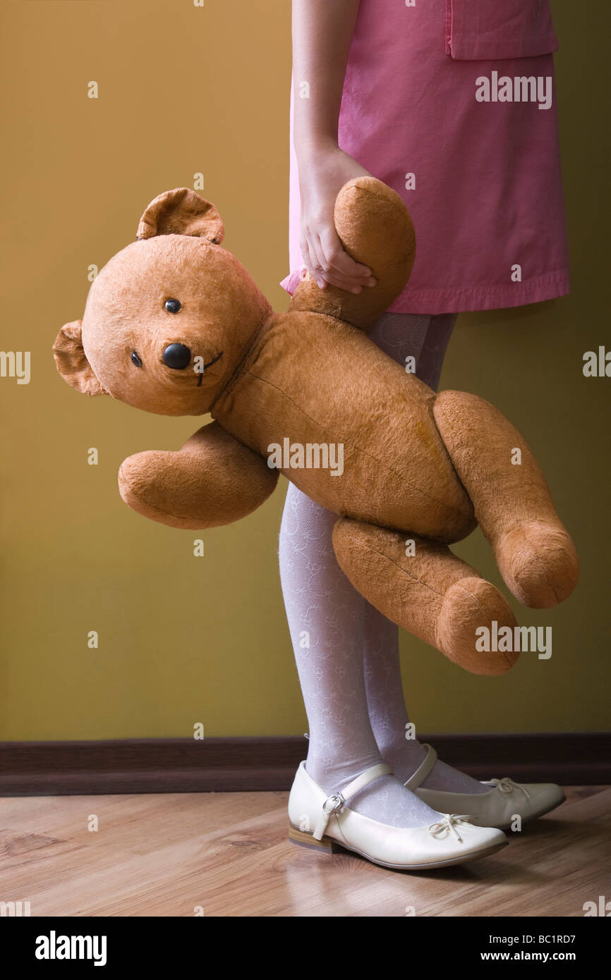 Girl holding teddy bear in home Stock Photo - Alamy