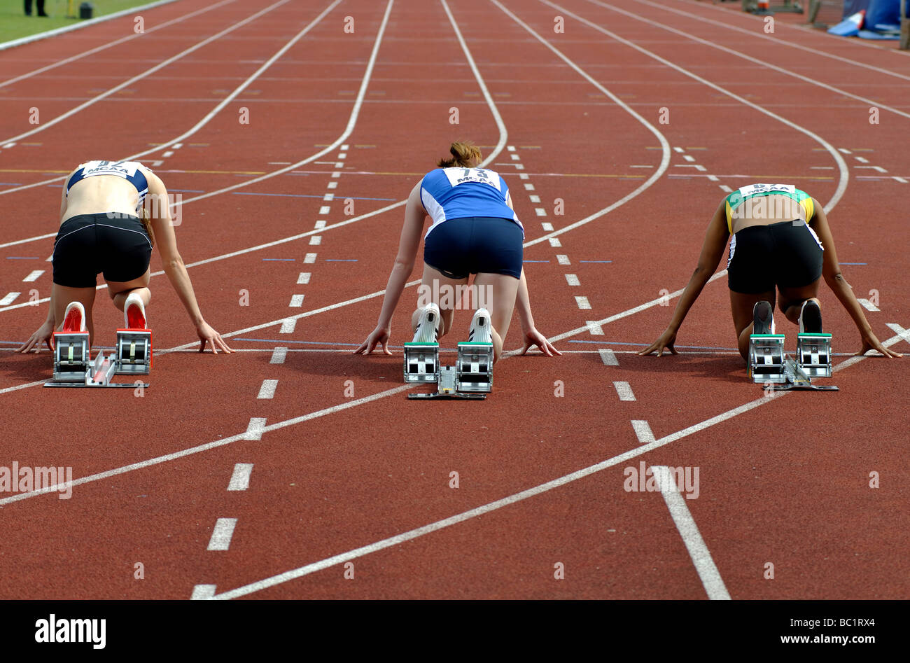 Female sprinters in starting blocks hi-res stock photography and images ...