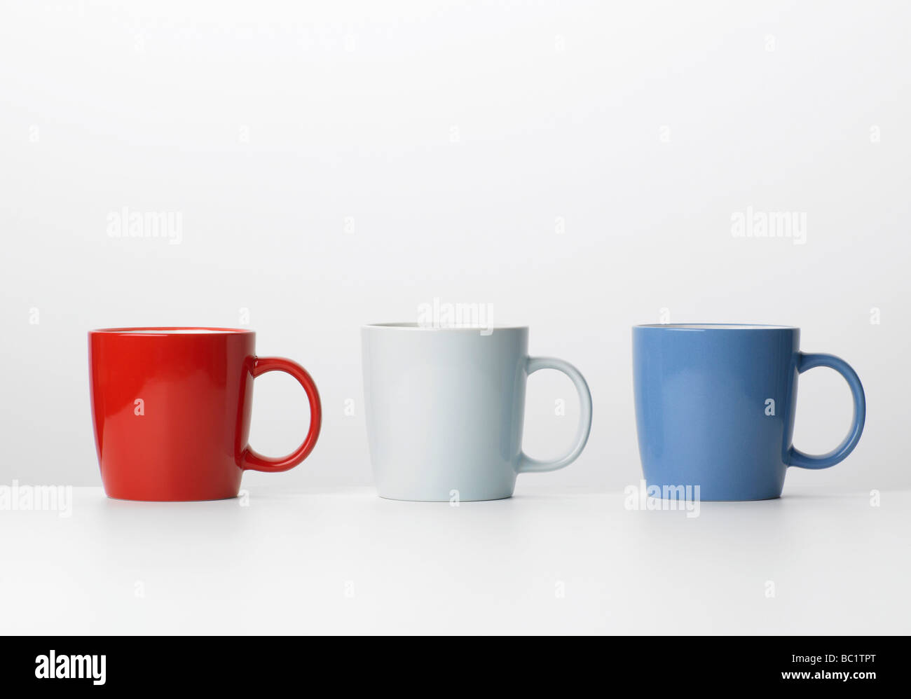 colored mugs red white and blue Stock Photo - Alamy