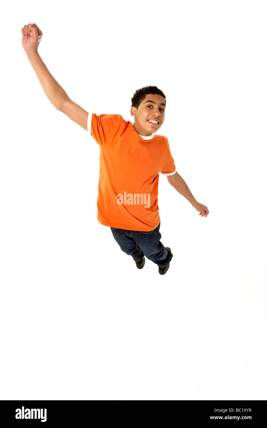 Young Boy Leaping In Studio Stock Photo - Alamy