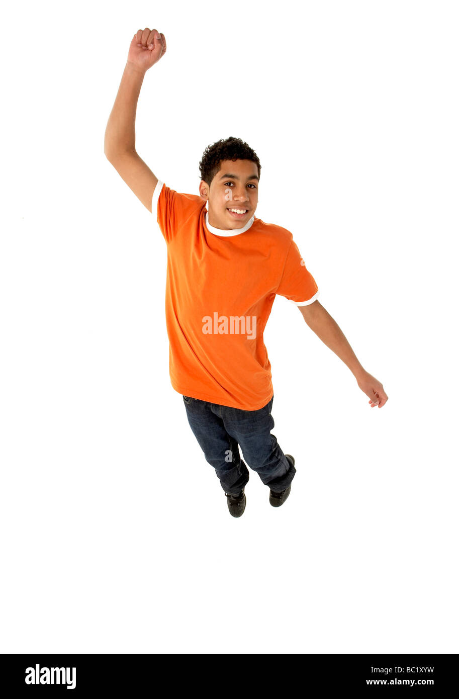Young Boy Leaping In Studio Stock Photo - Alamy