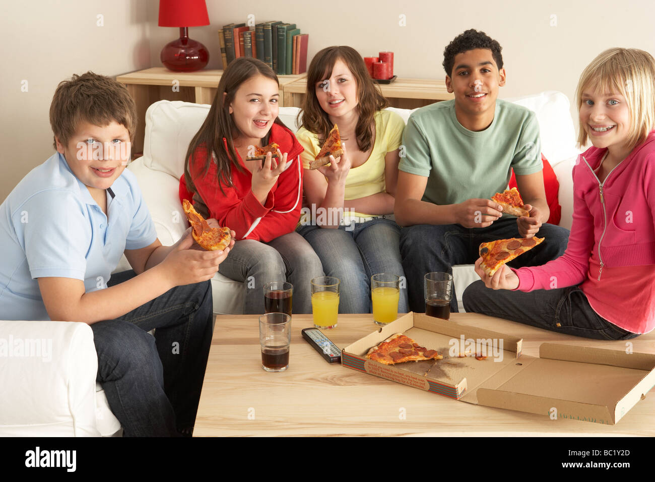 Group Of Children Eating Pizza At Home Stock Photo - Alamy