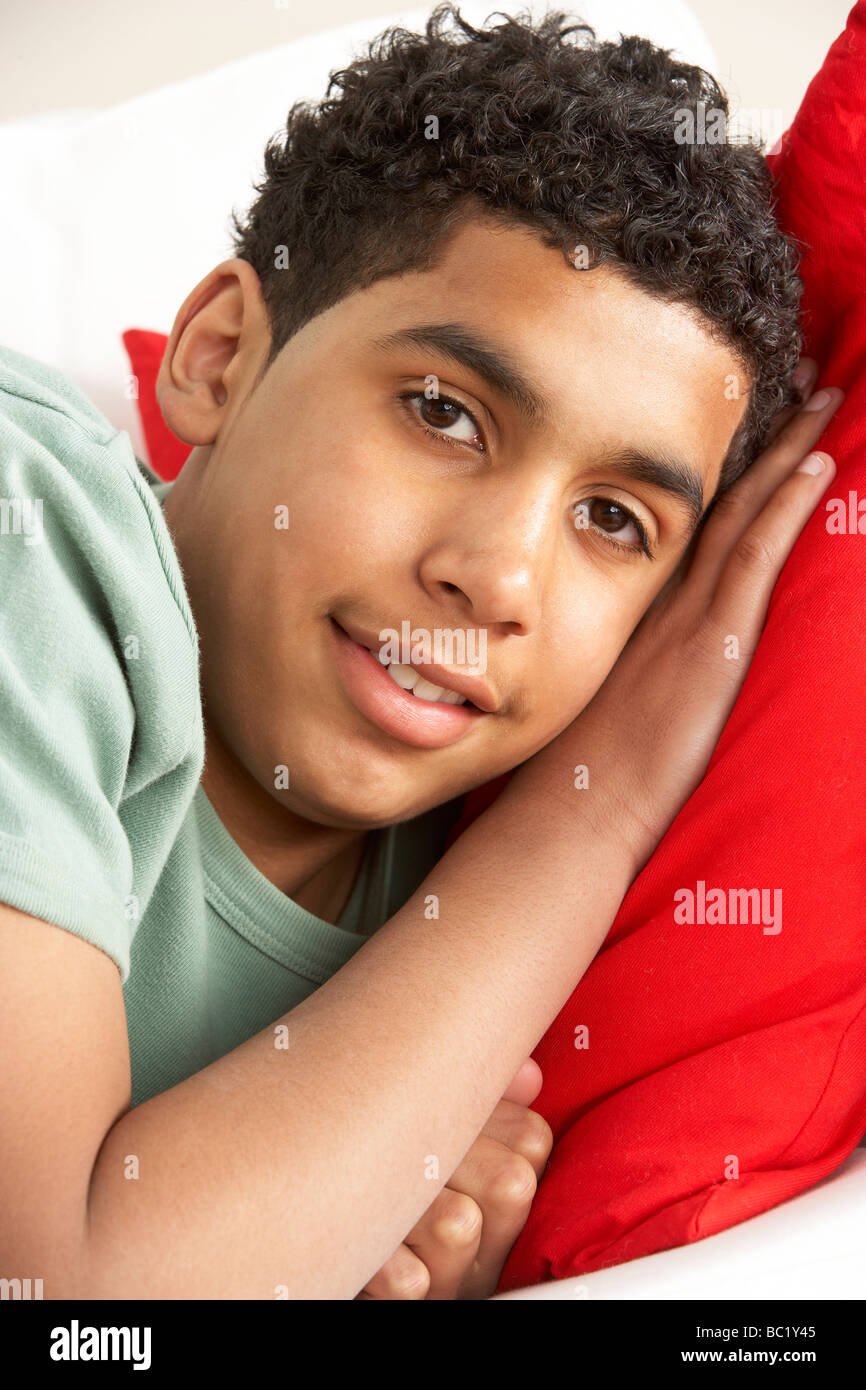 Young Boy Relaxing On Sofa Stock Photo - Alamy