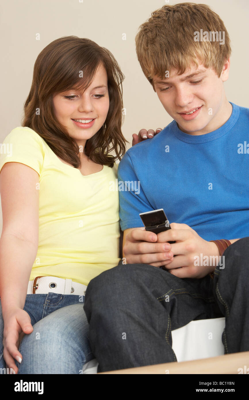Teenage Couple Reading Text Message Stock Photo - Alamy