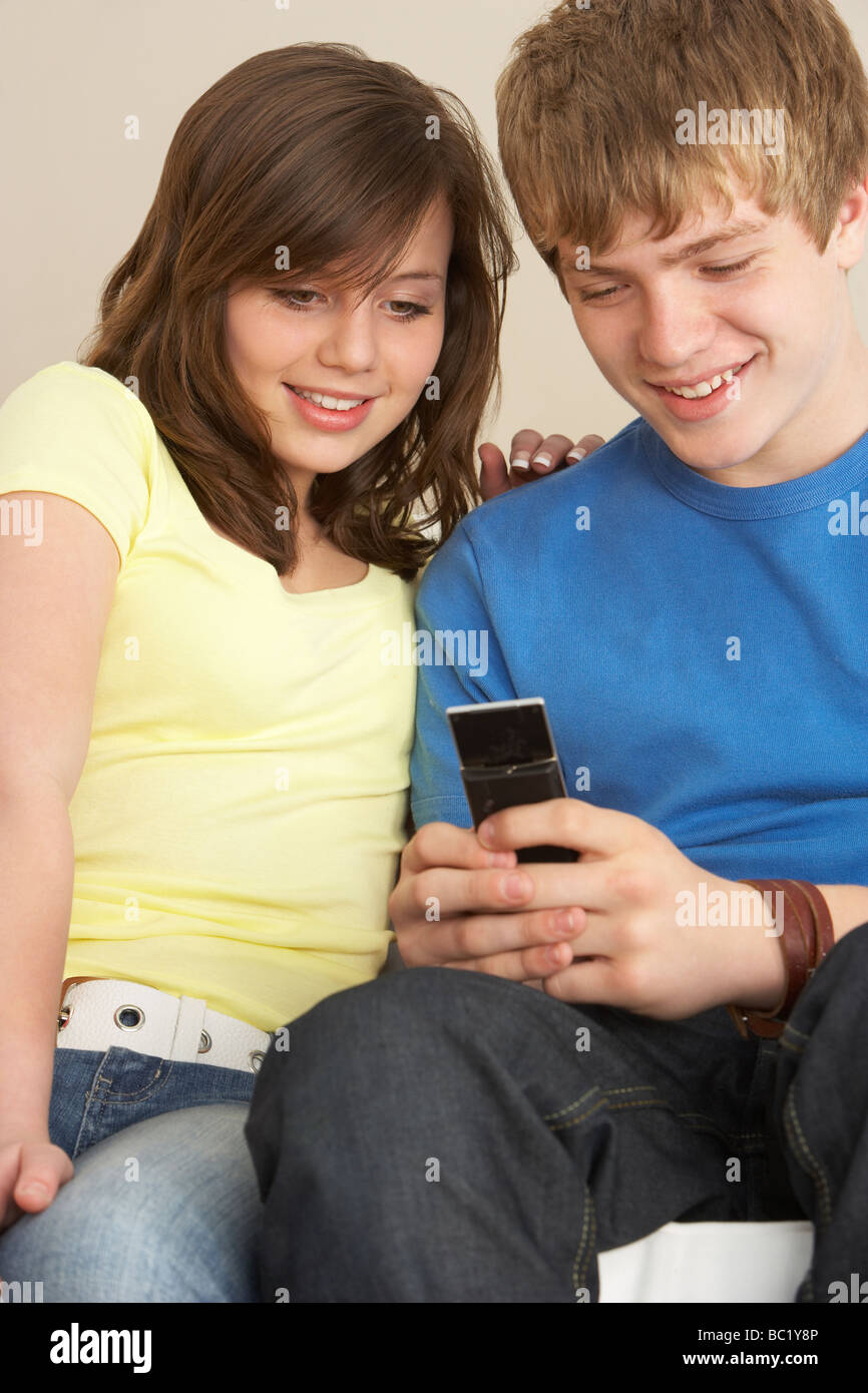 Teenage Couple Reading Text Message Stock Photo - Alamy