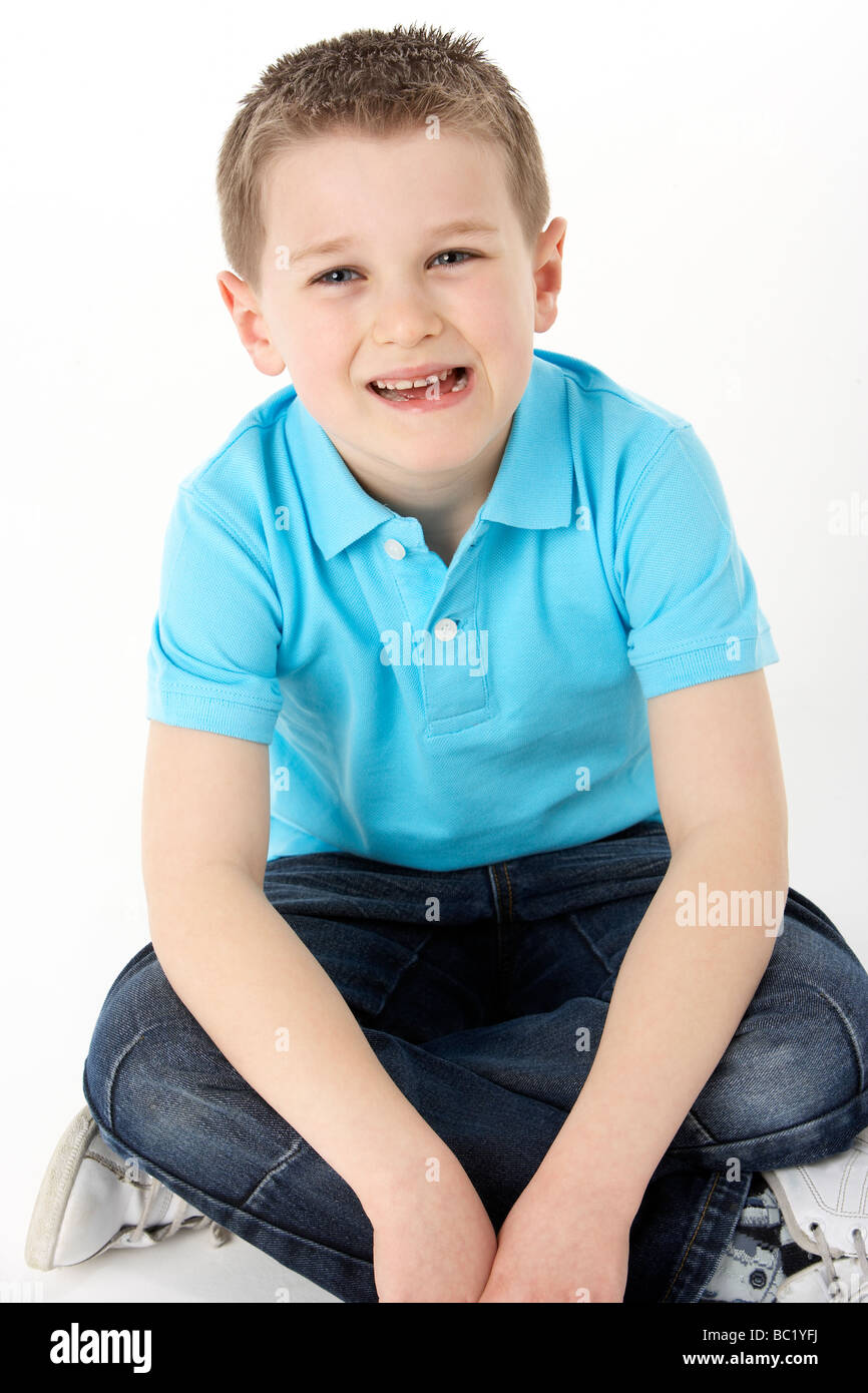 Young Boy Sitting In Studio Stock Photo - Alamy