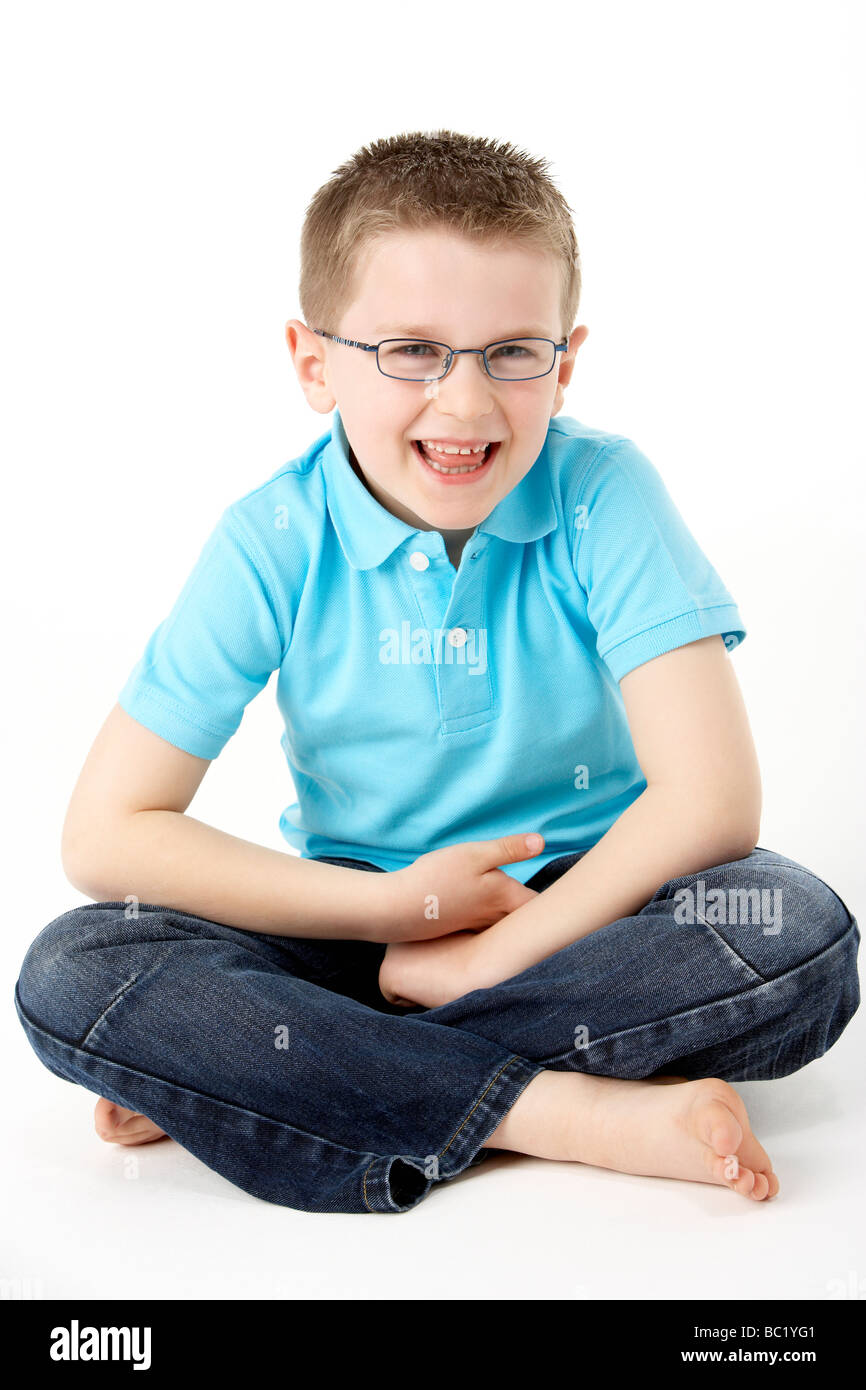 Young Boy Sitting In Studio Stock Photo - Alamy