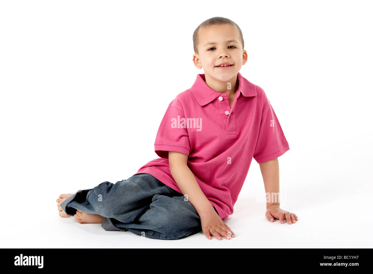 Young Boy Sitting In Studio Stock Photo - Alamy