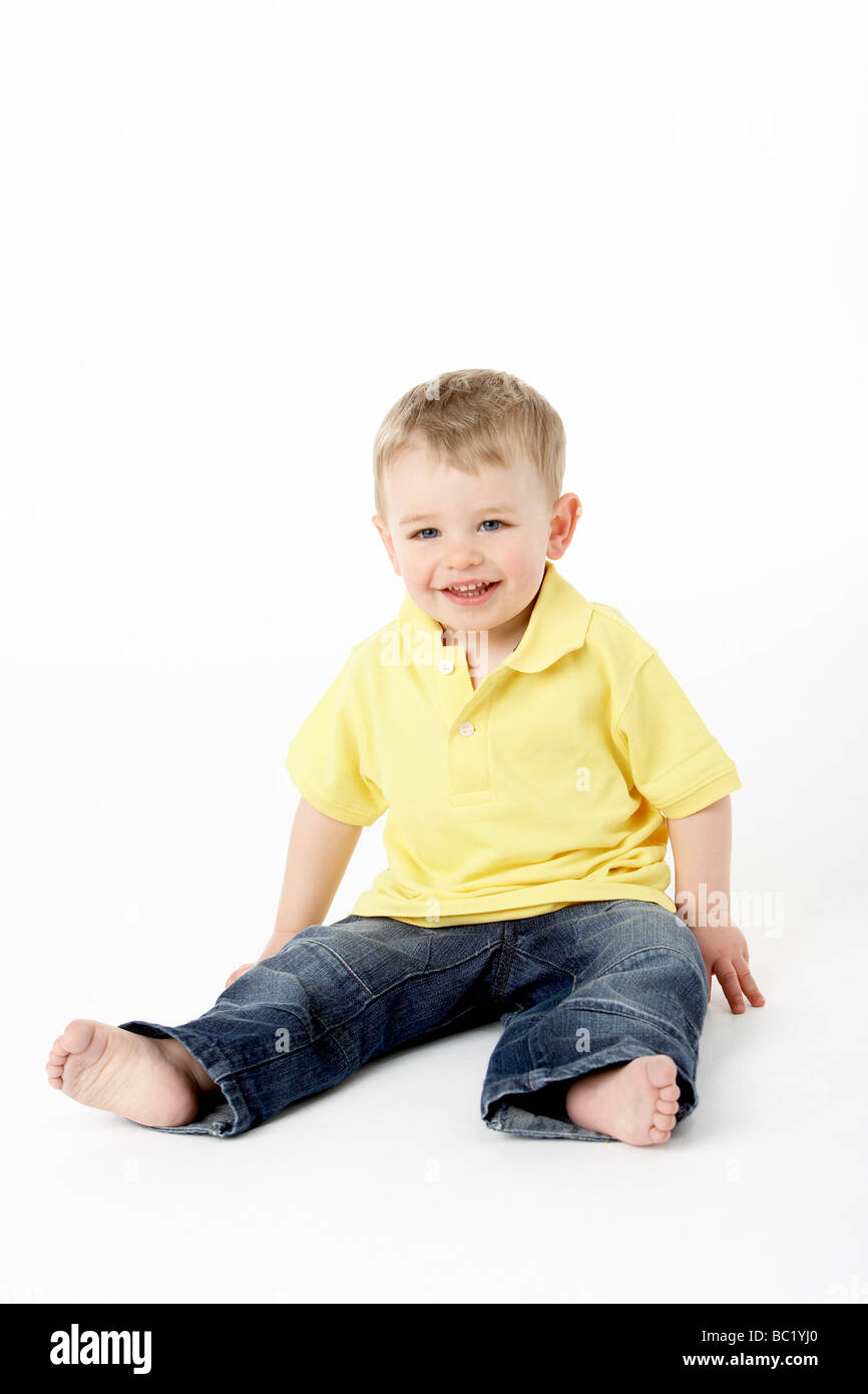 Young Boy Sitting In Studio Stock Photo - Alamy
