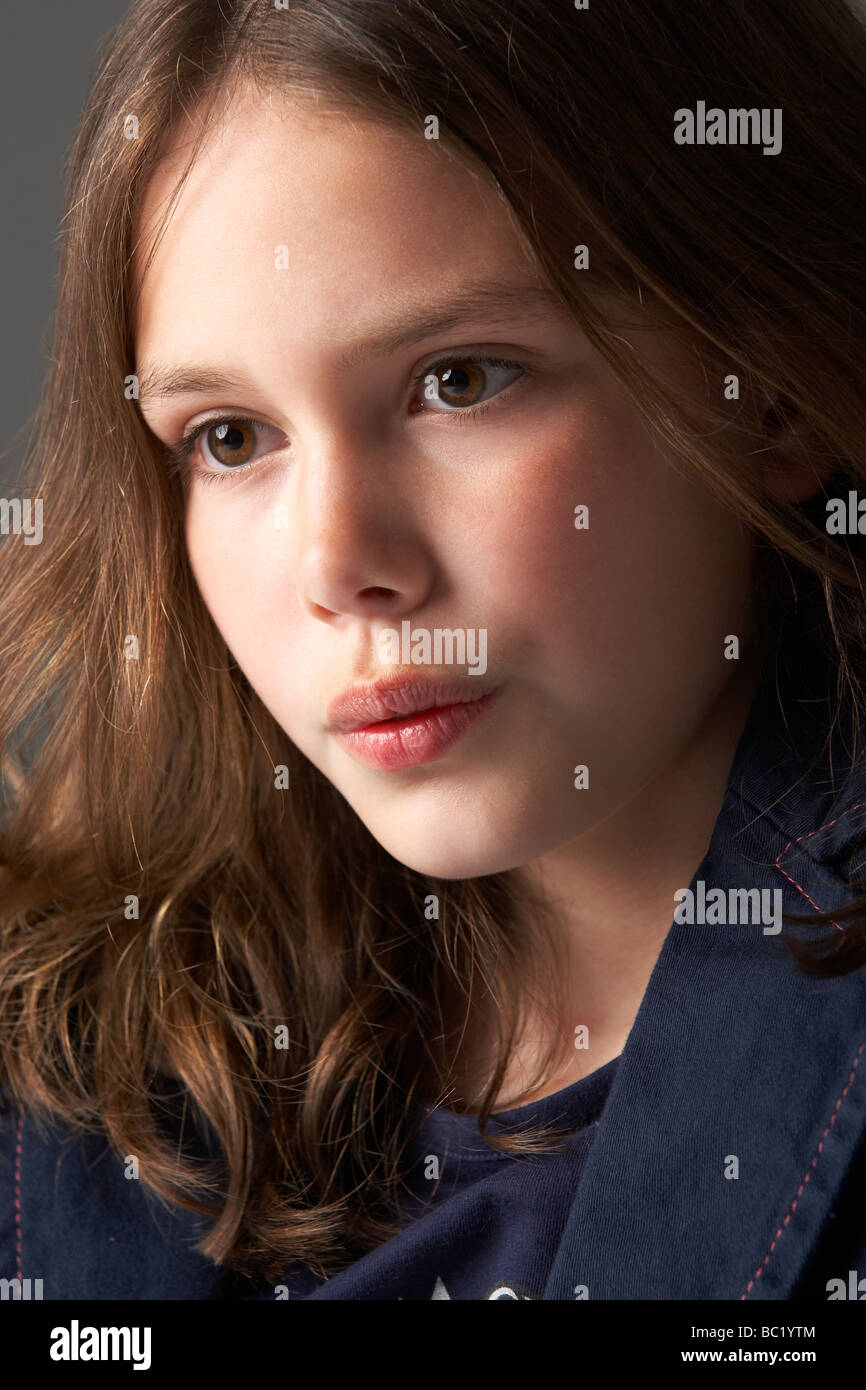 Thoughtful Girl Sitting In Studio Stock Photo - Alamy