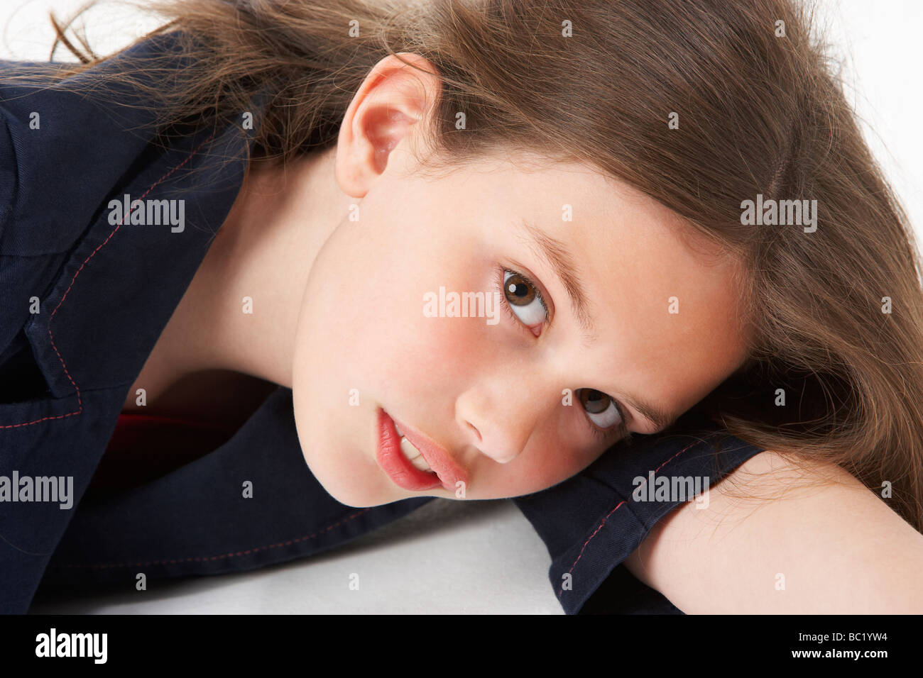 Thoughtful Girl Sitting In Studio Stock Photo - Alamy