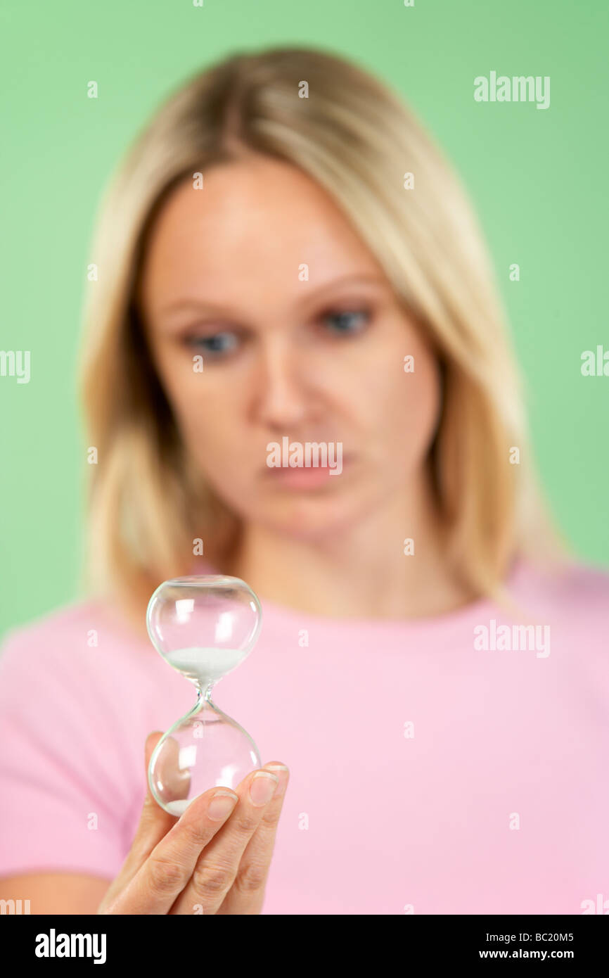 Woman Holding Hourglass Stock Photo - Alamy