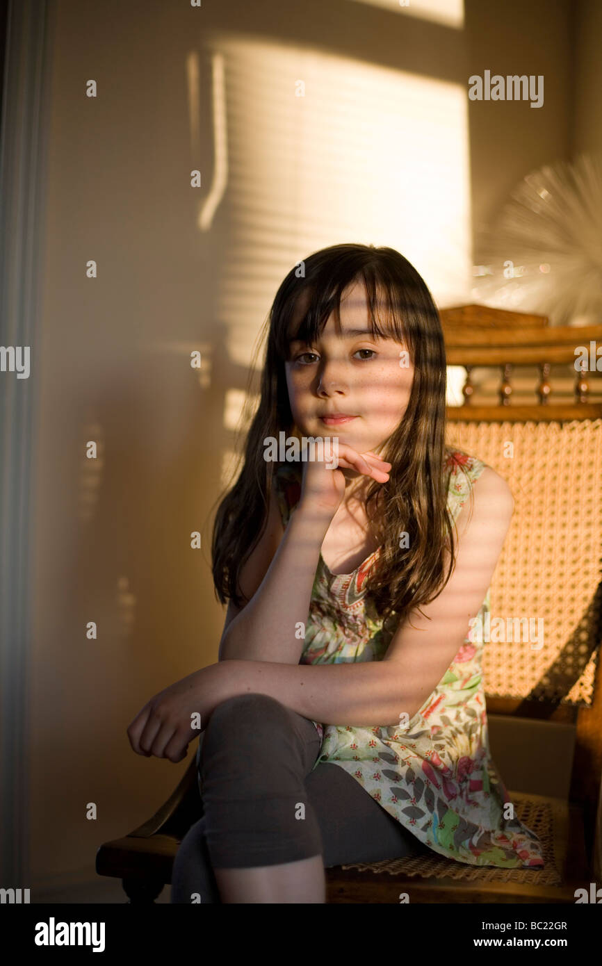 Young girl sitting in rocking chair Stock Photo - Alamy