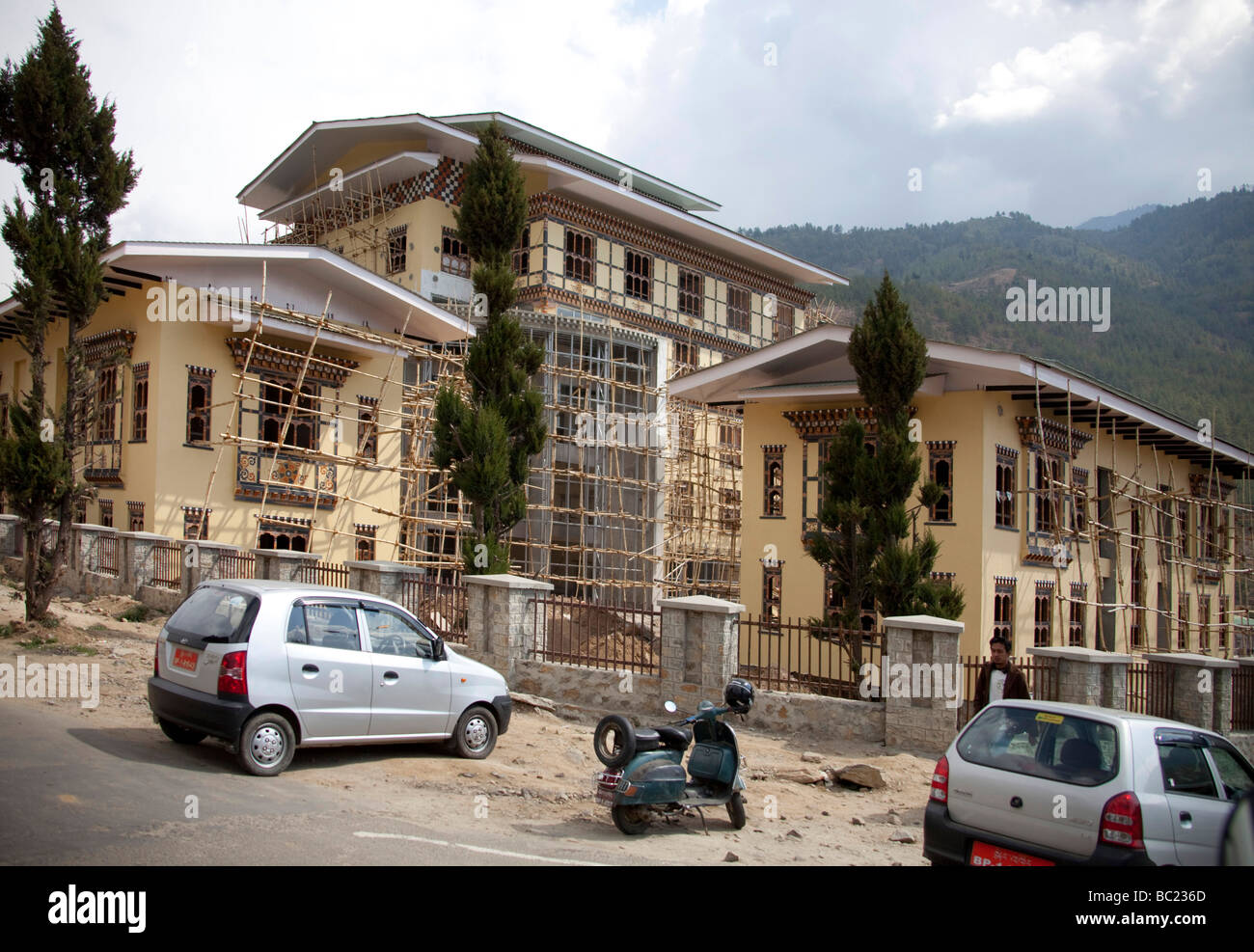 typical house building being constructed with scaffolds in Thimphu ...