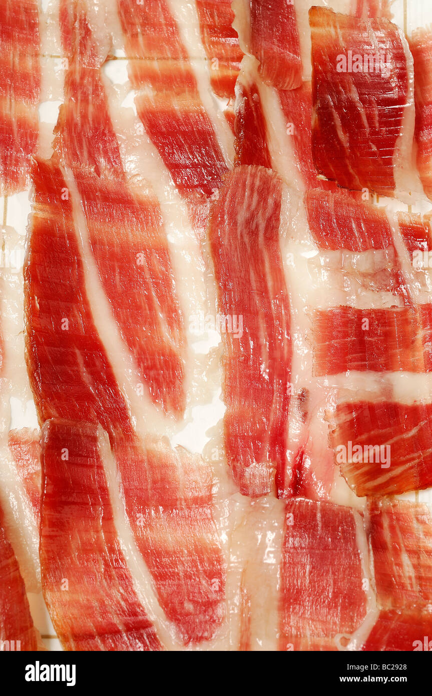 Cutting Spanish ham, process of preparation and it cuts Stock Photo - Alamy