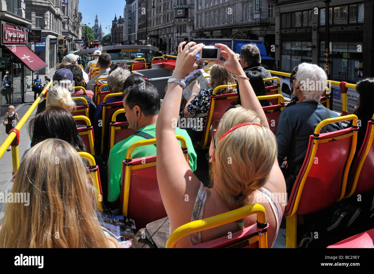 London top deck of open top tour bus passengers taking pictures Stock ...