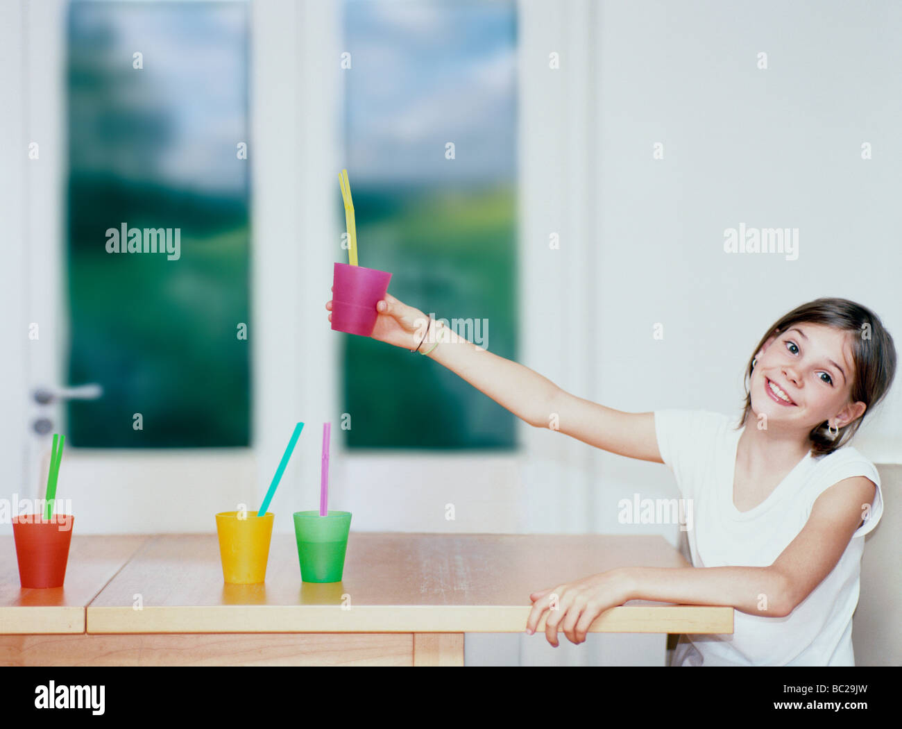 young girl holding a cup in celebratory pose Stock Photo - Alamy